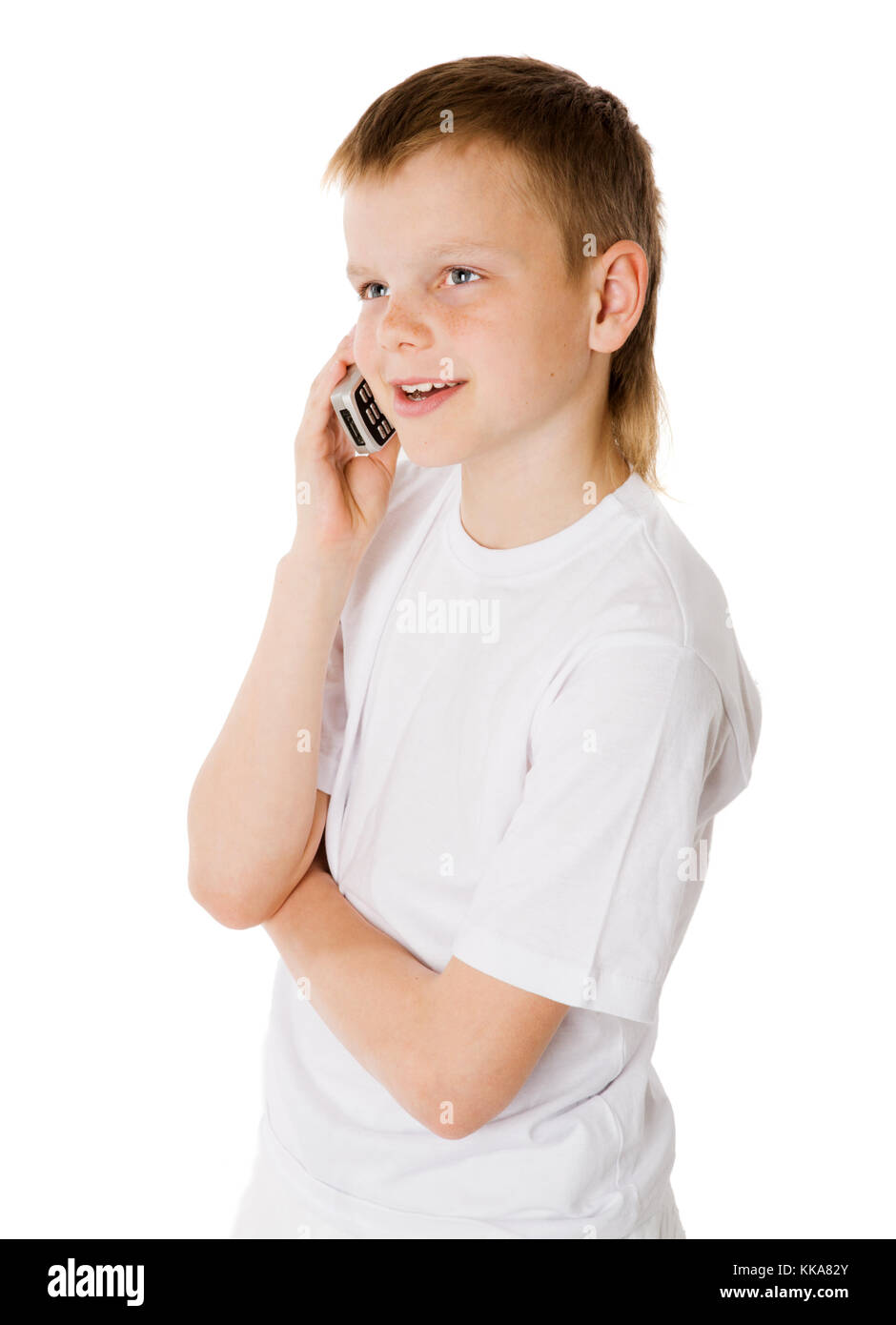 Young boy talking on cell phone isolated on white Stock Photo - Alamy