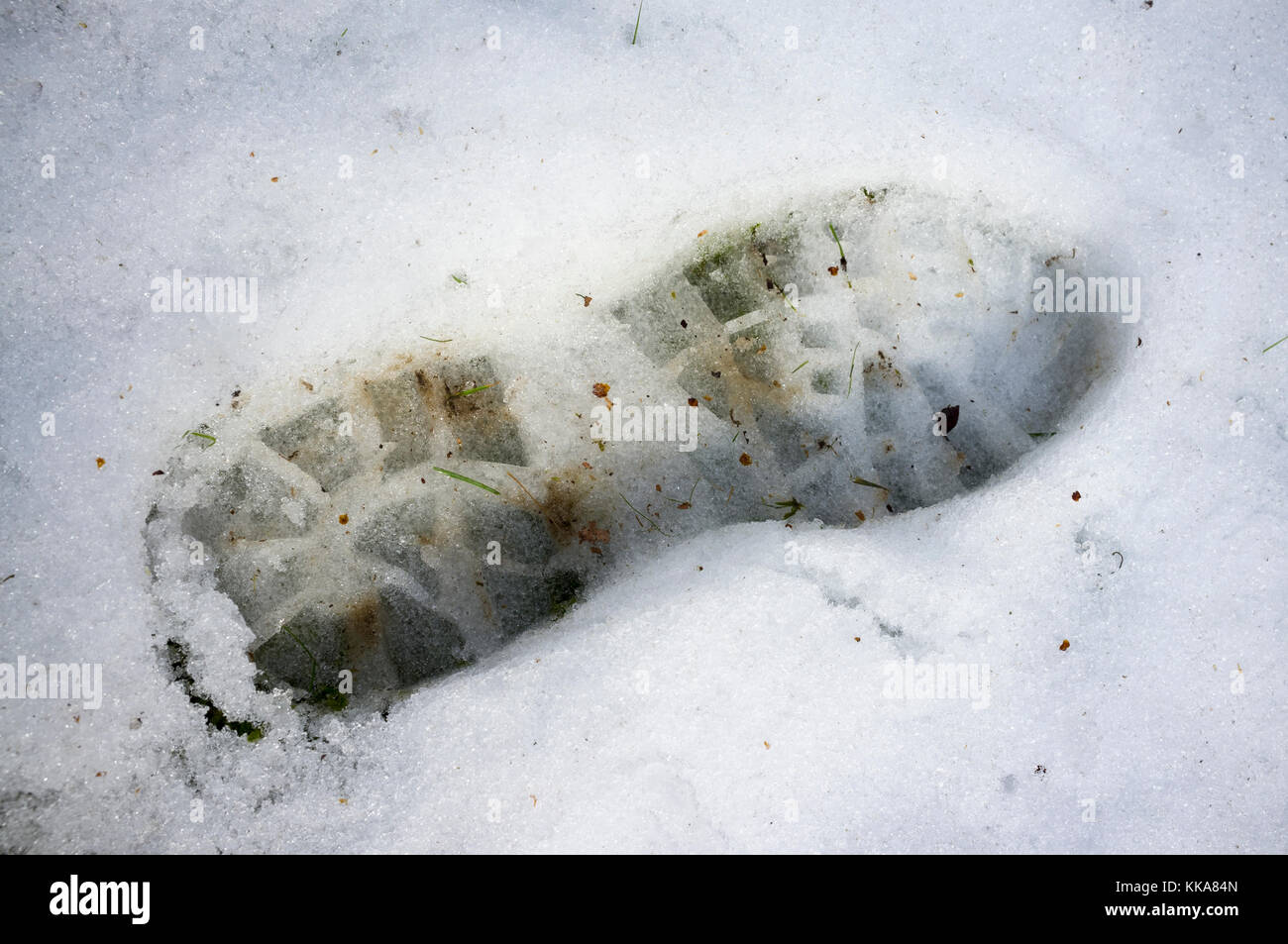 A footprint of a boot in the snow Stock Photo - Alamy