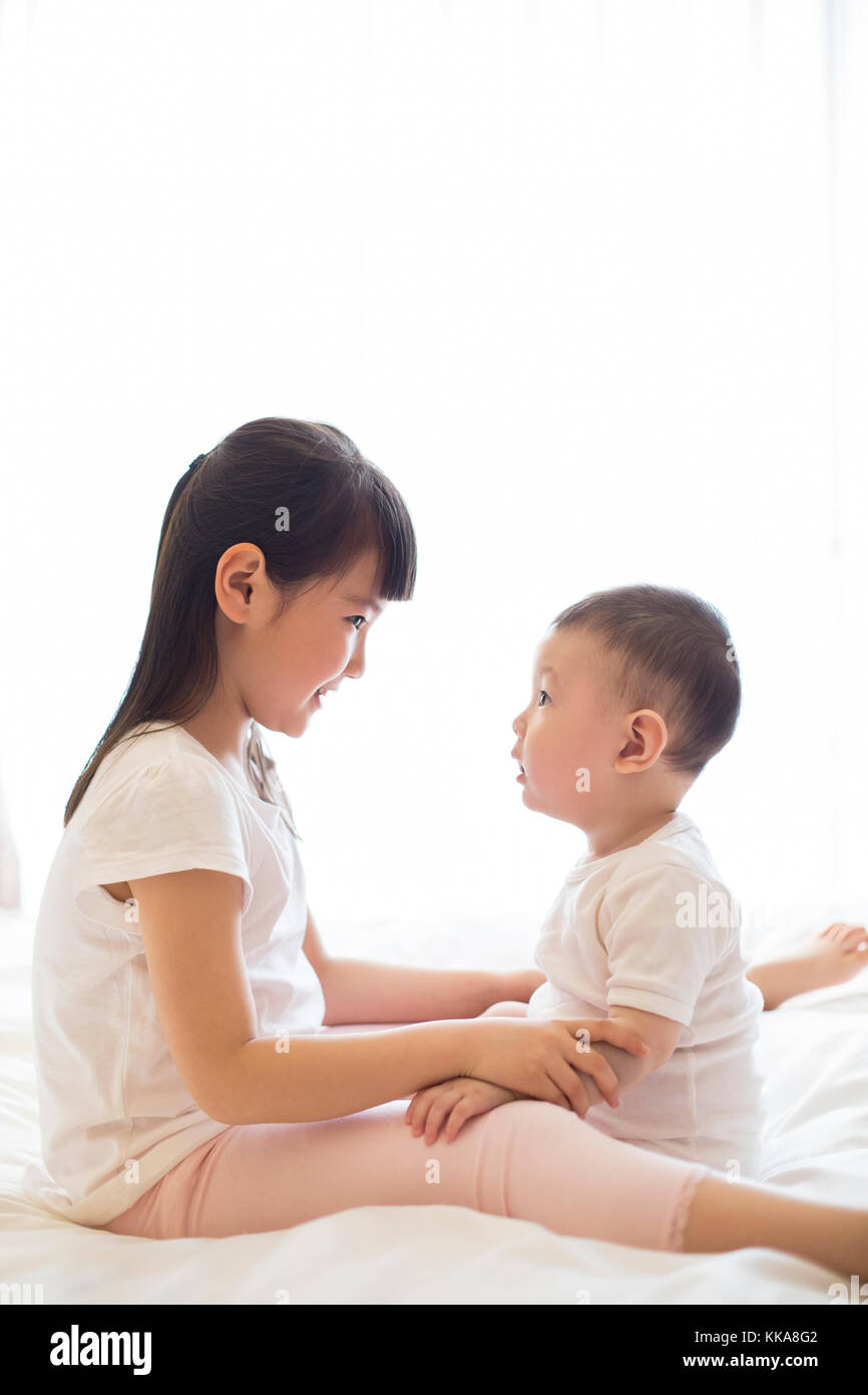 Little Chinese girl and baby boy Stock Photo - Alamy