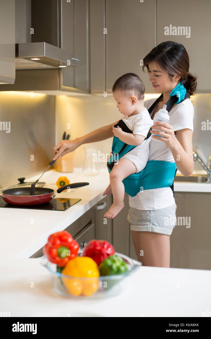 Indian mother and son in kitchen hi-res stock photography and images ...