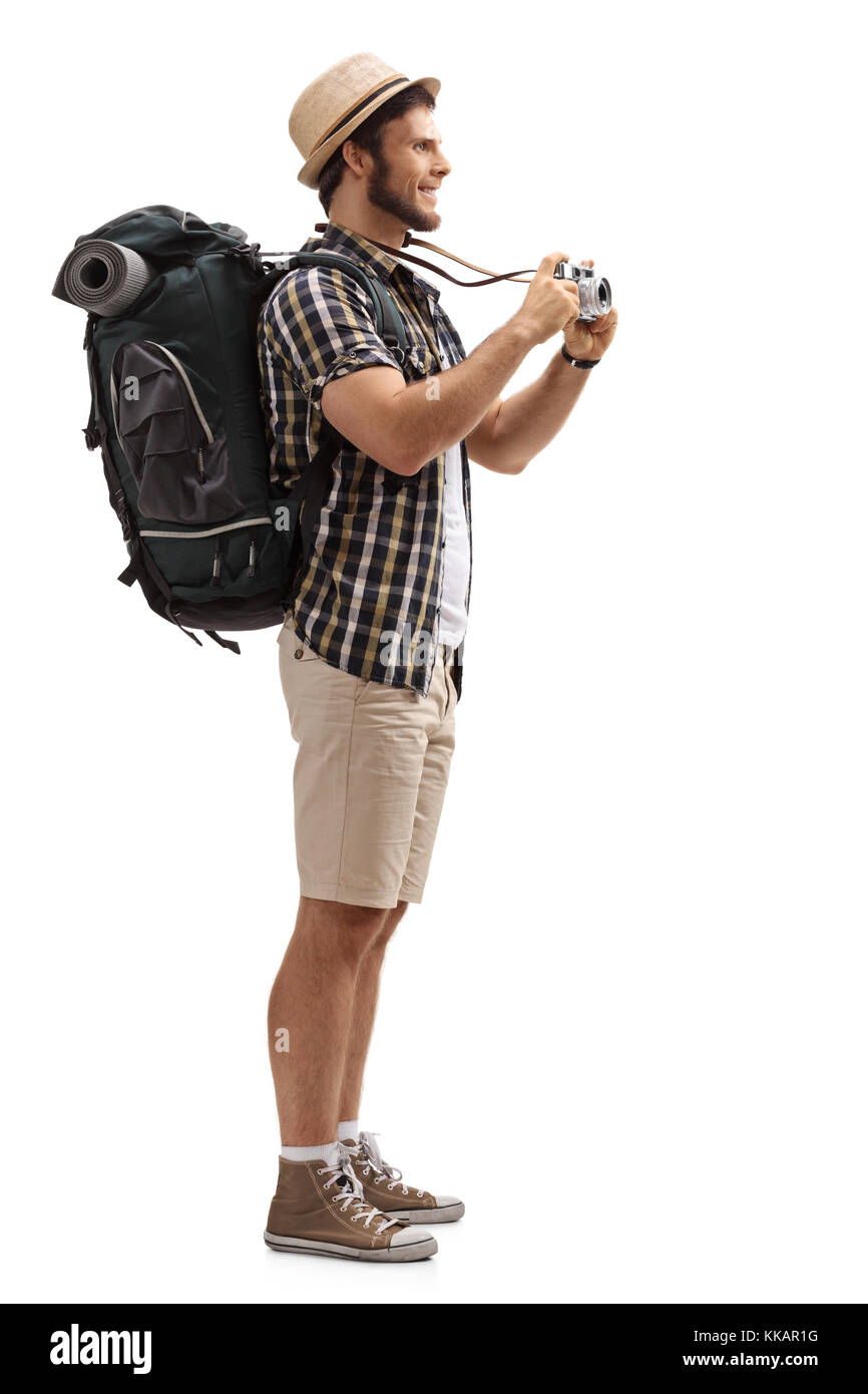 Full length profile shot of a tourist with a backpack and a camera ...