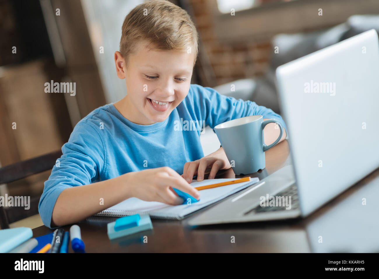 Positive smart boy using highlighter Stock Photo - Alamy