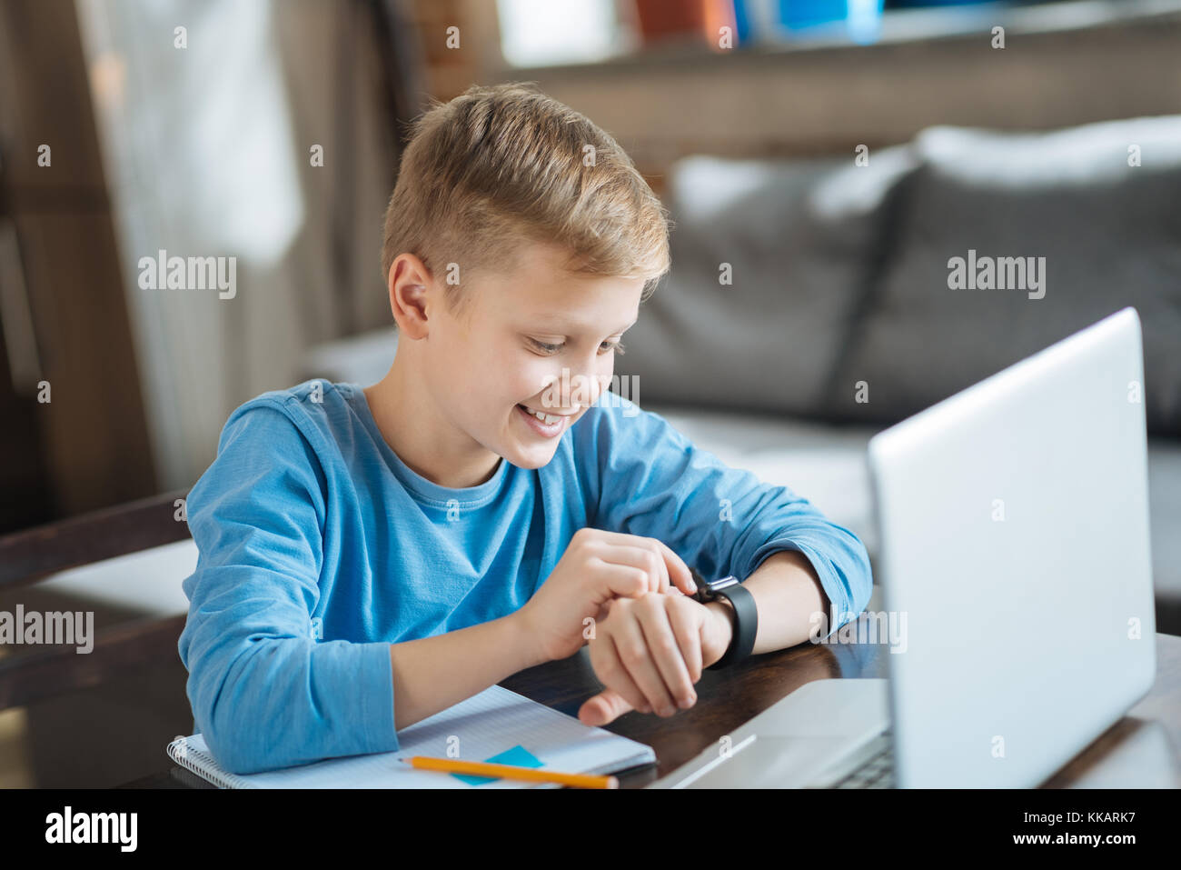 Nice positive boy checking the time Stock Photo - Alamy