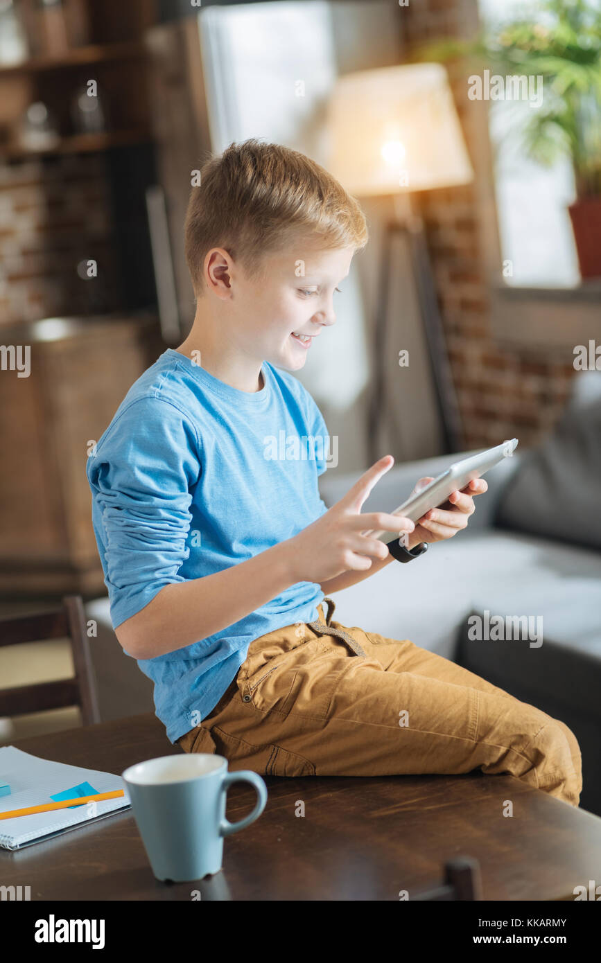 Positive cheerful boy using a tablet Stock Photo - Alamy