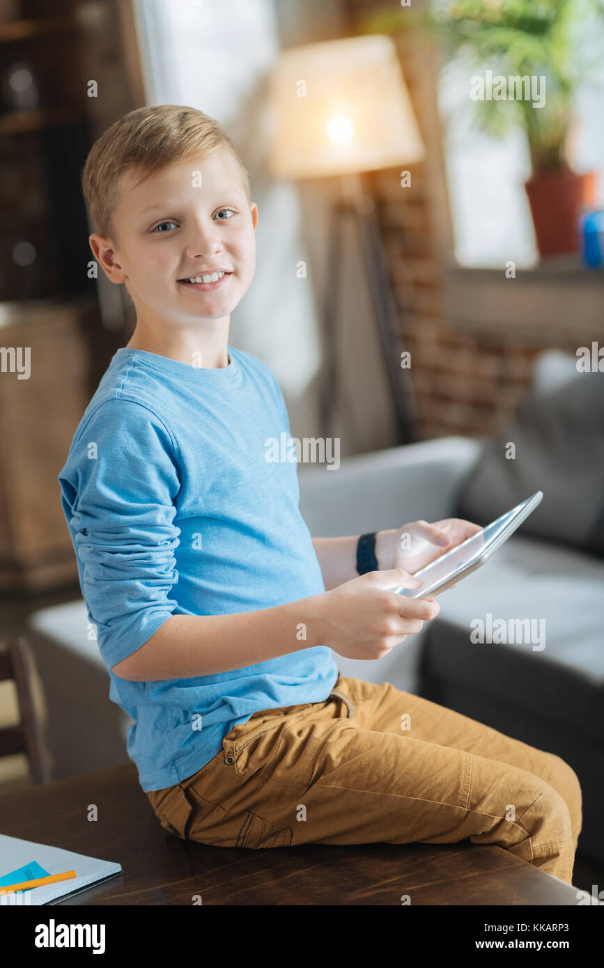 Nice cheerful boy using modern technology Stock Photo - Alamy