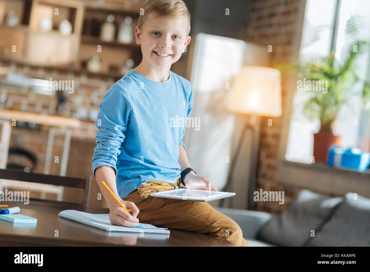 Happy delighted boy holding a pencil Stock Photo - Alamy
