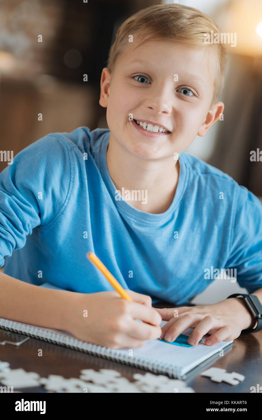 Happy positive boy doing a school task Stock Photo - Alamy