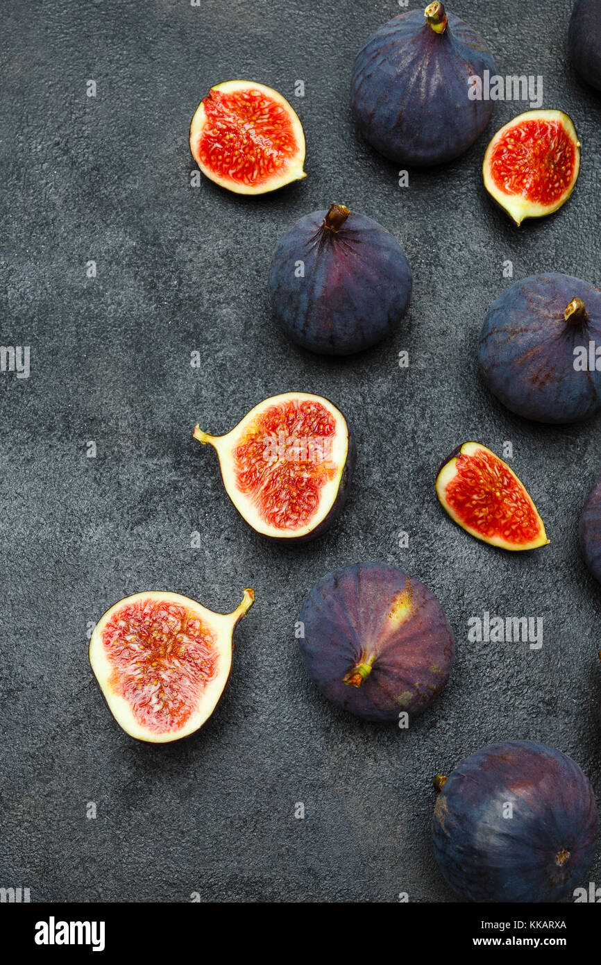 Fig isolated on dark concrete background Stock Photo - Alamy