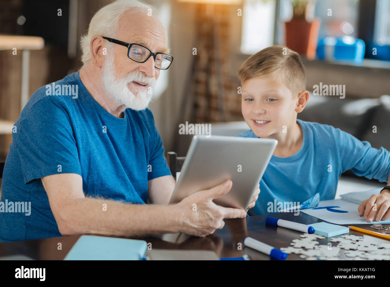Cheerful elderly man using electronic device Stock Photo - Alamy