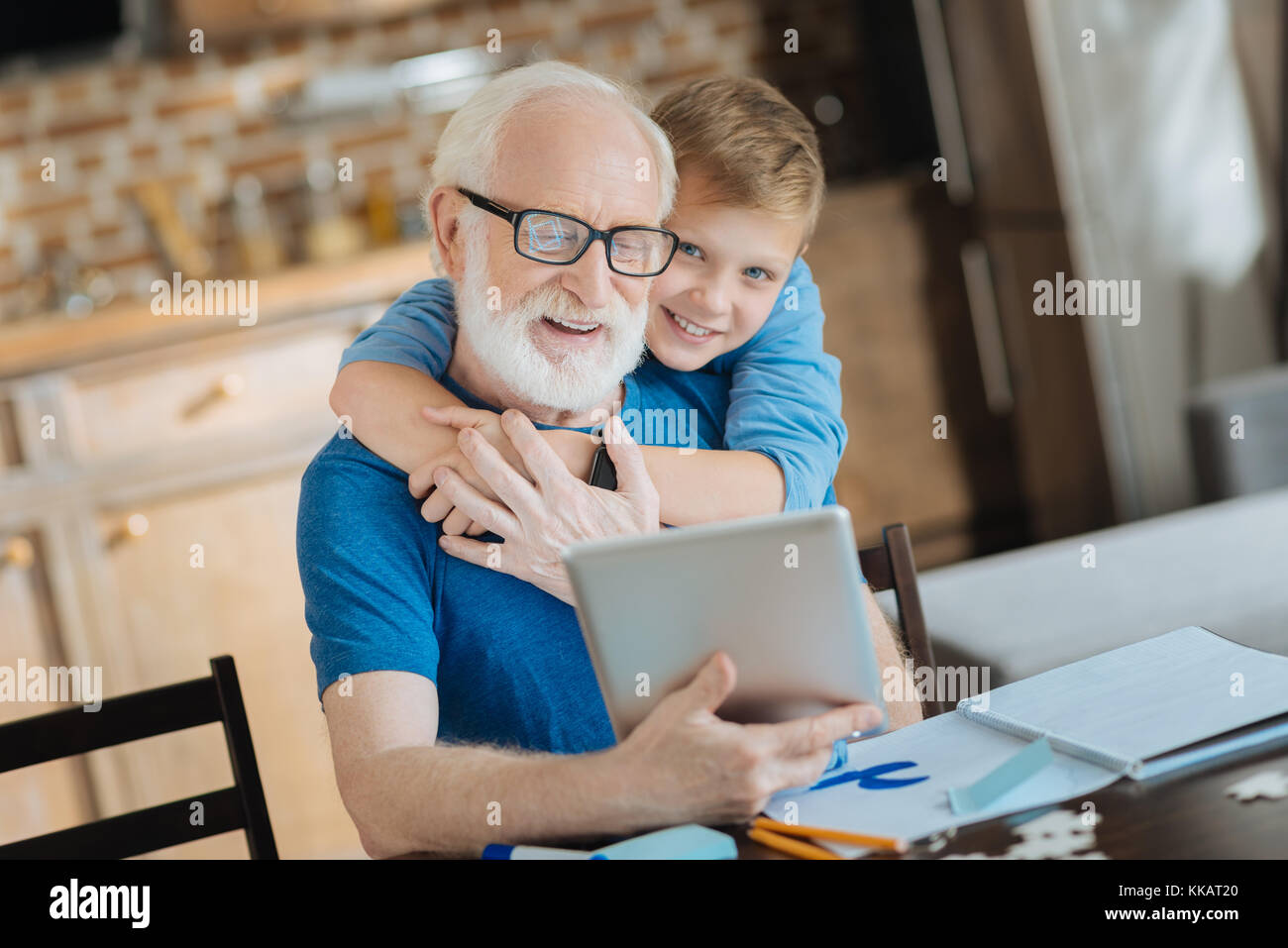 Happy cute boy hugging his grandfather Stock Photo - Alamy