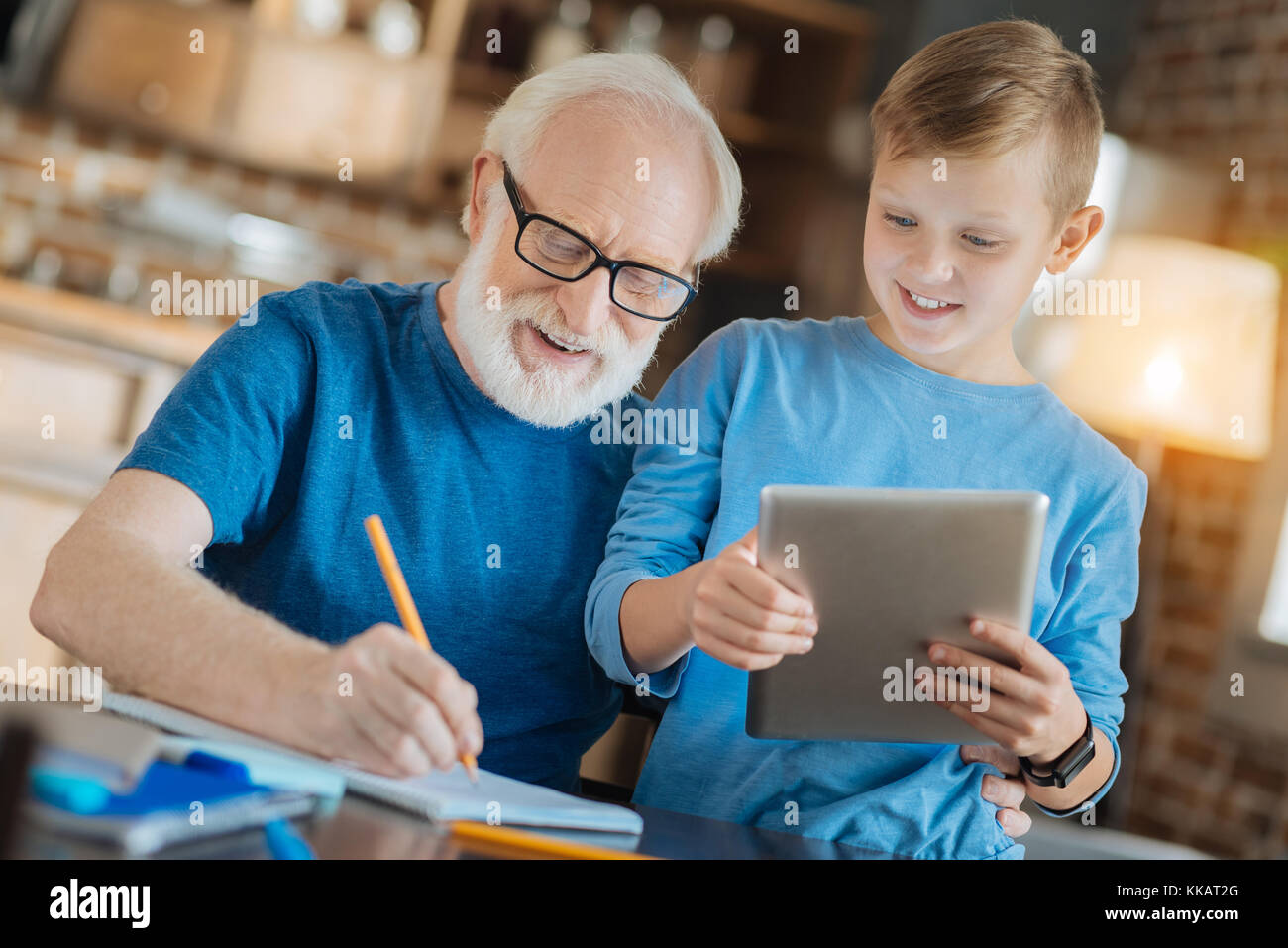 Happy delighted man taking notes Stock Photo - Alamy