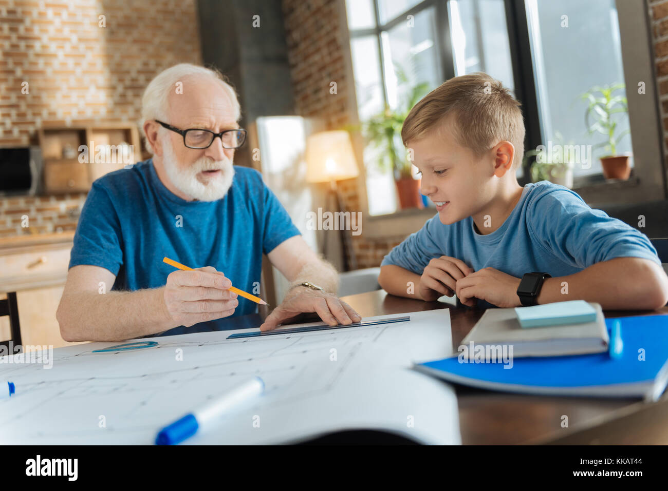Serious aged man holding a ruler Stock Photo - Alamy