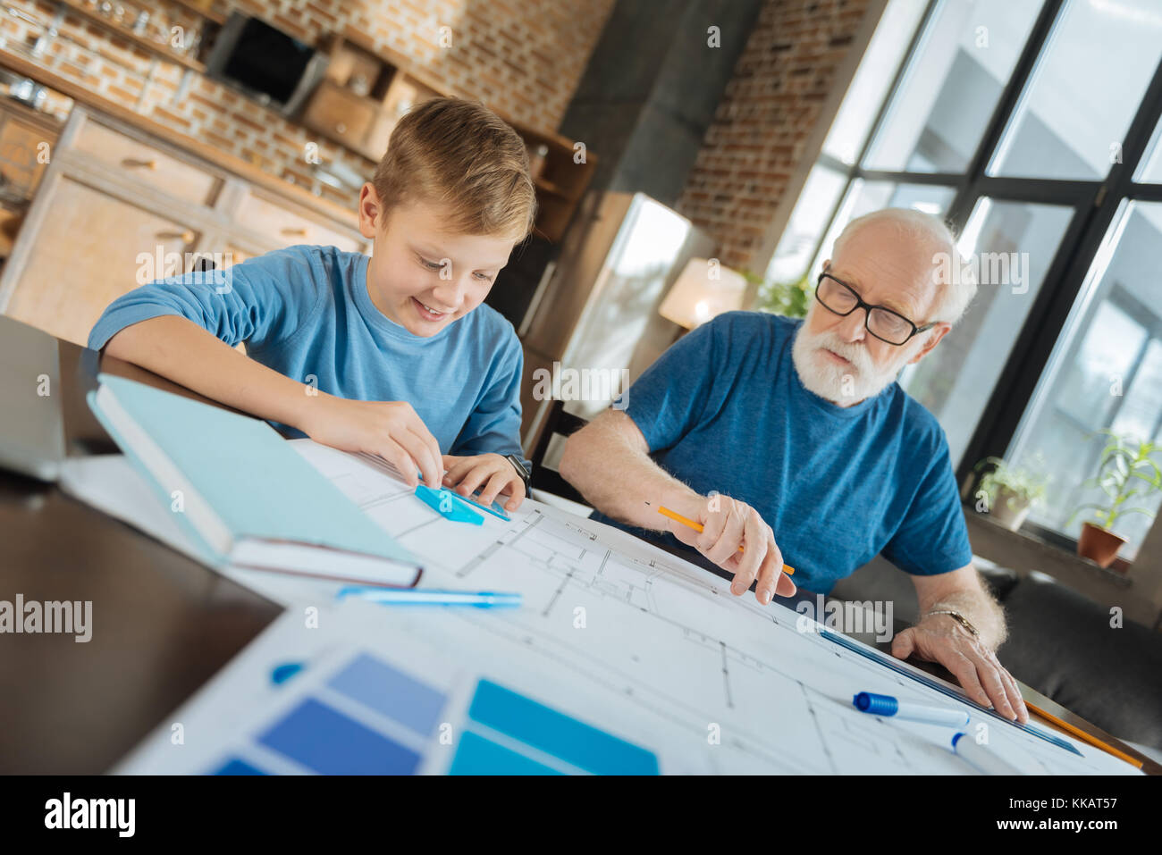 Happy positive boy working on a project Stock Photo - Alamy