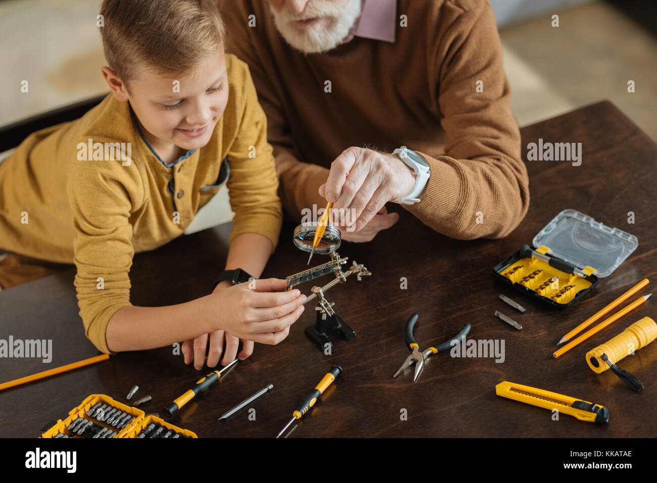 Positive cute boy learning new skills Stock Photo - Alamy