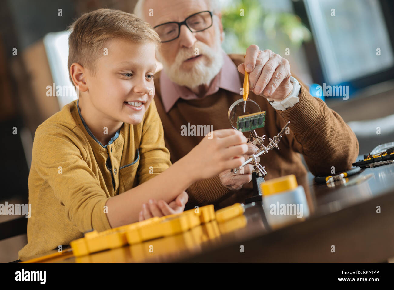 Joyful positive boy working with his grandfather Stock Photo - Alamy