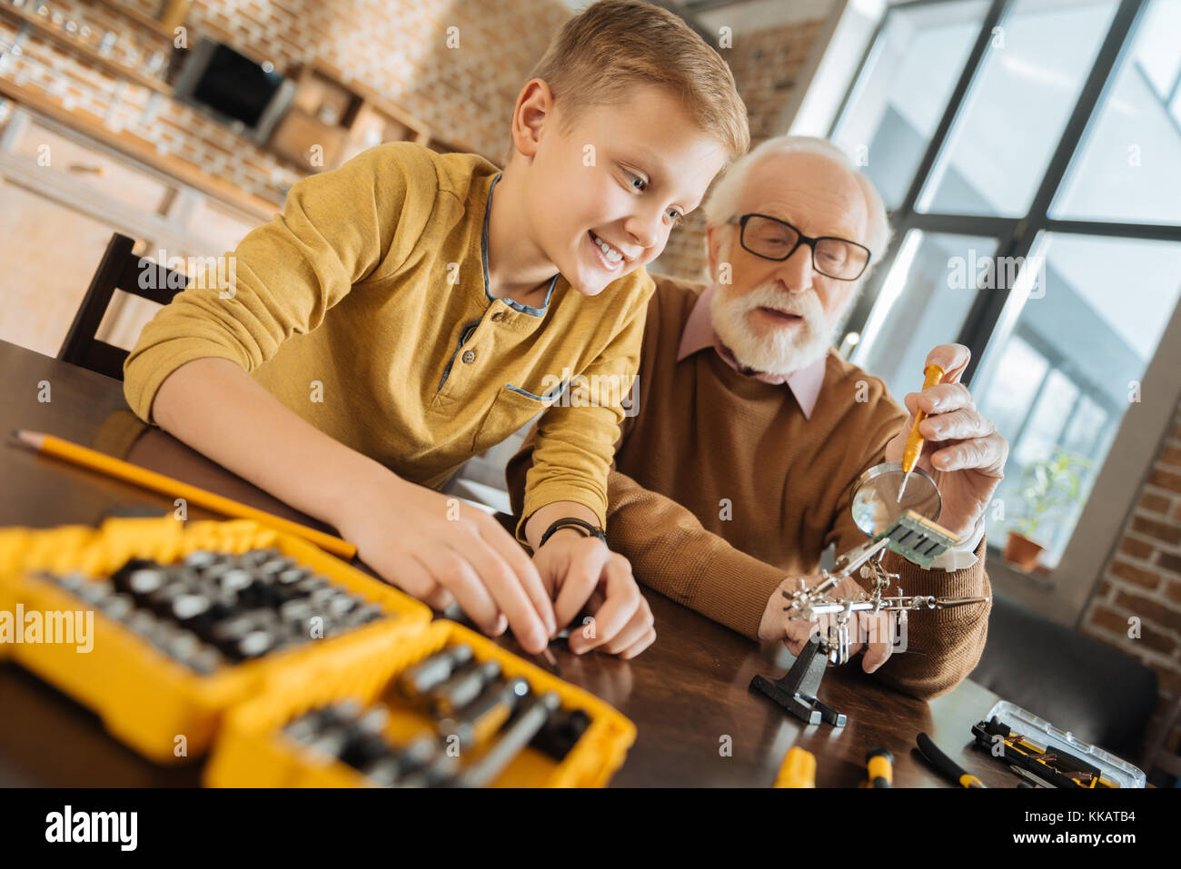 Happy delighted boy learning new skills Stock Photo - Alamy