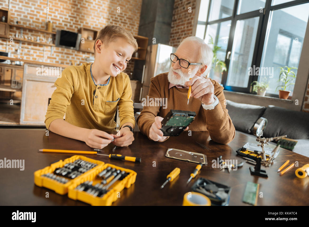Delighted positive boy talking to his grandfather Stock Photo - Alamy
