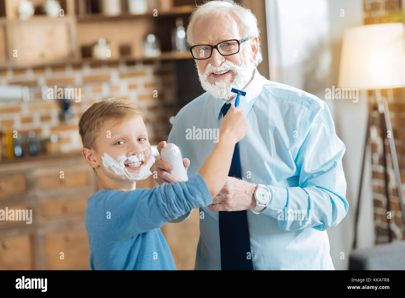 Happy cheerful boy holding a razor Stock Photo - Alamy