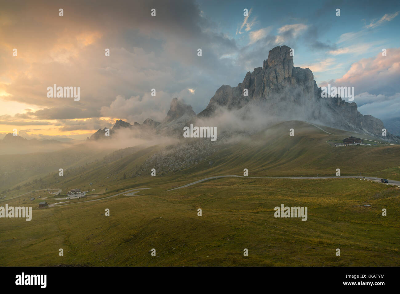 View of landscape and winding road from Marmolada Pass at sunset, South ...