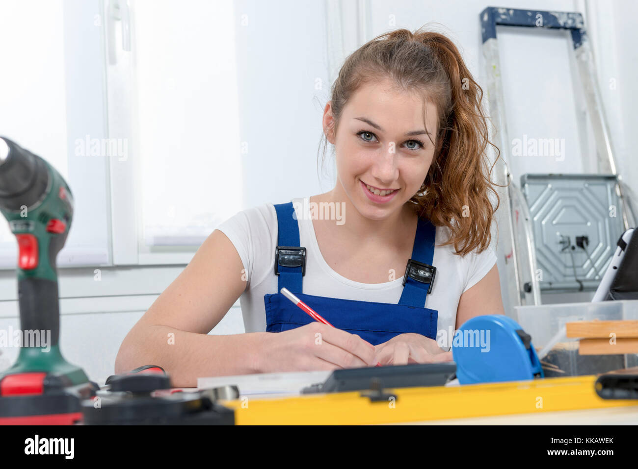 young woman carpenter sitting at desk in her workshop Stock Photo - Alamy
