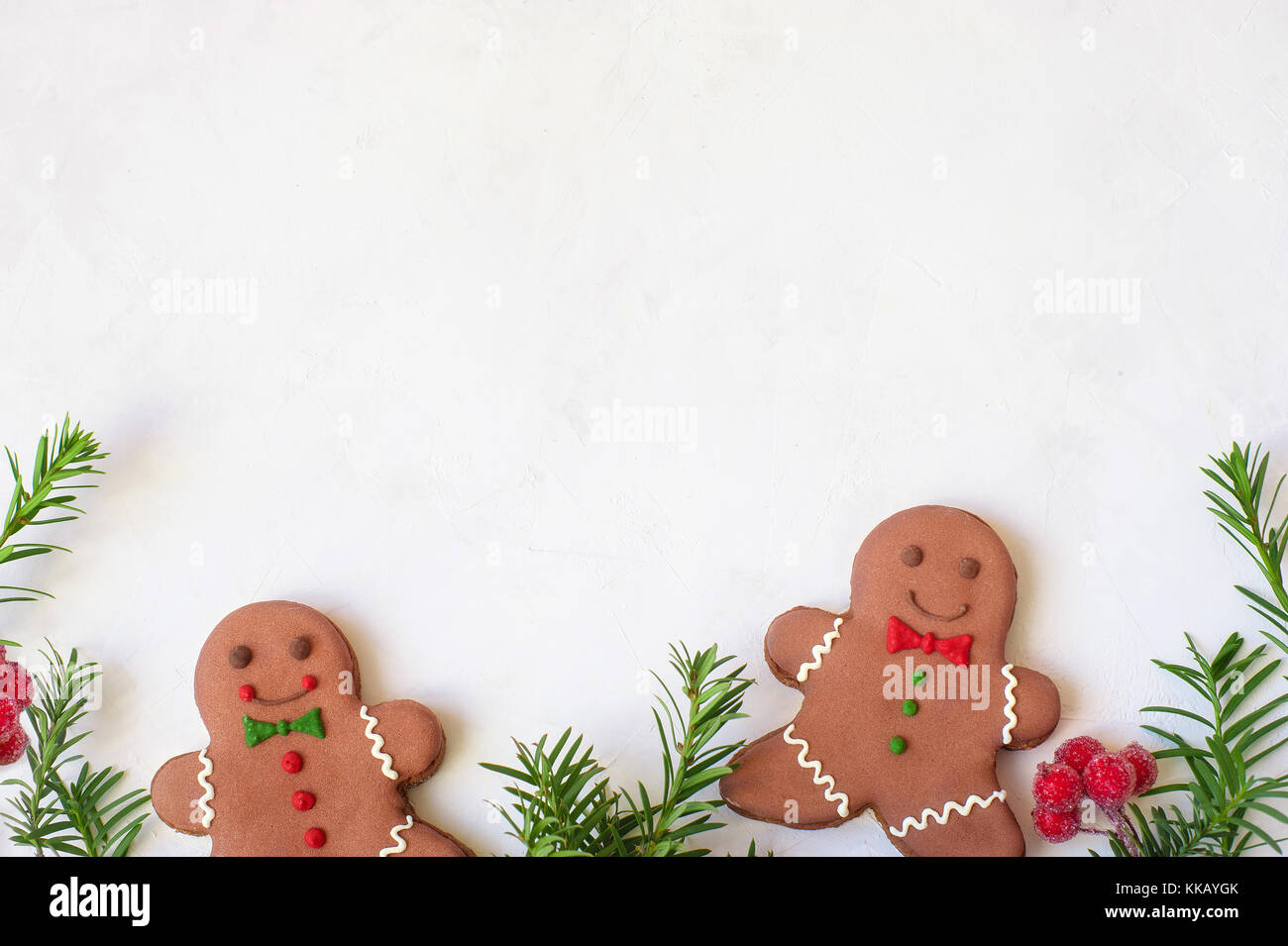 Two gingerbread man with candy standing on a white background ...