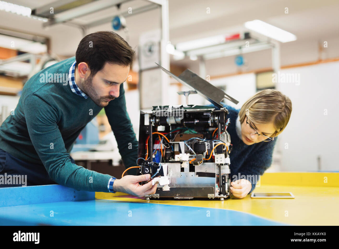Young attractive students of mechatronics working on project Stock ...