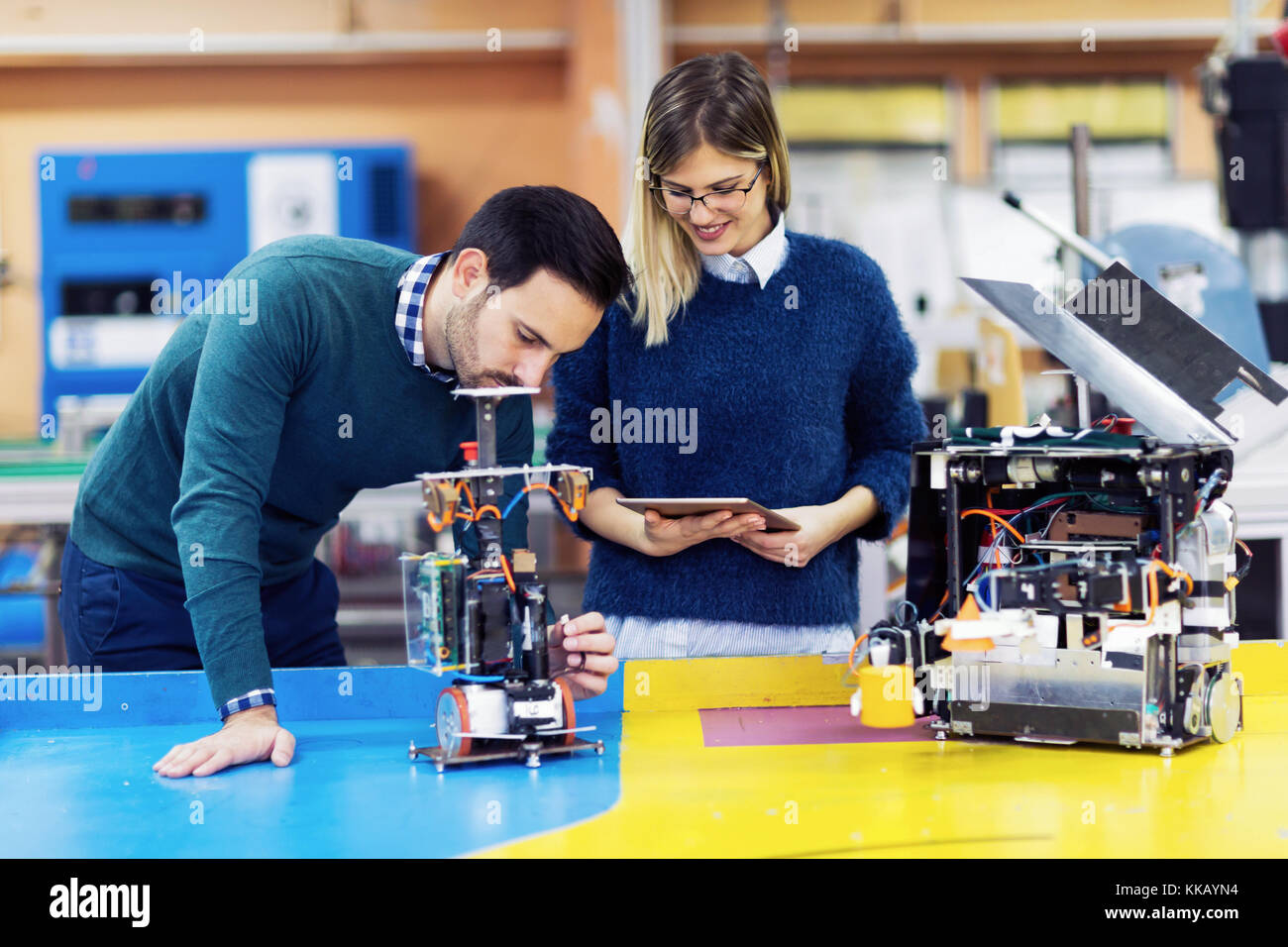 Young attractive students of mechatronics working on project Stock ...