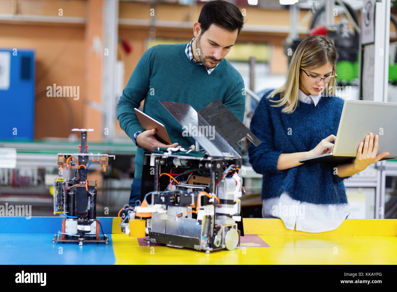 Young attractive students of mechatronics working on project Stock ...