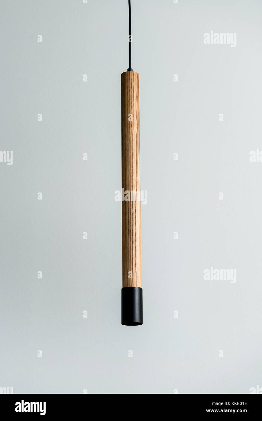 Hanging wooden tube lamp with metal part Stock Photo - Alamy