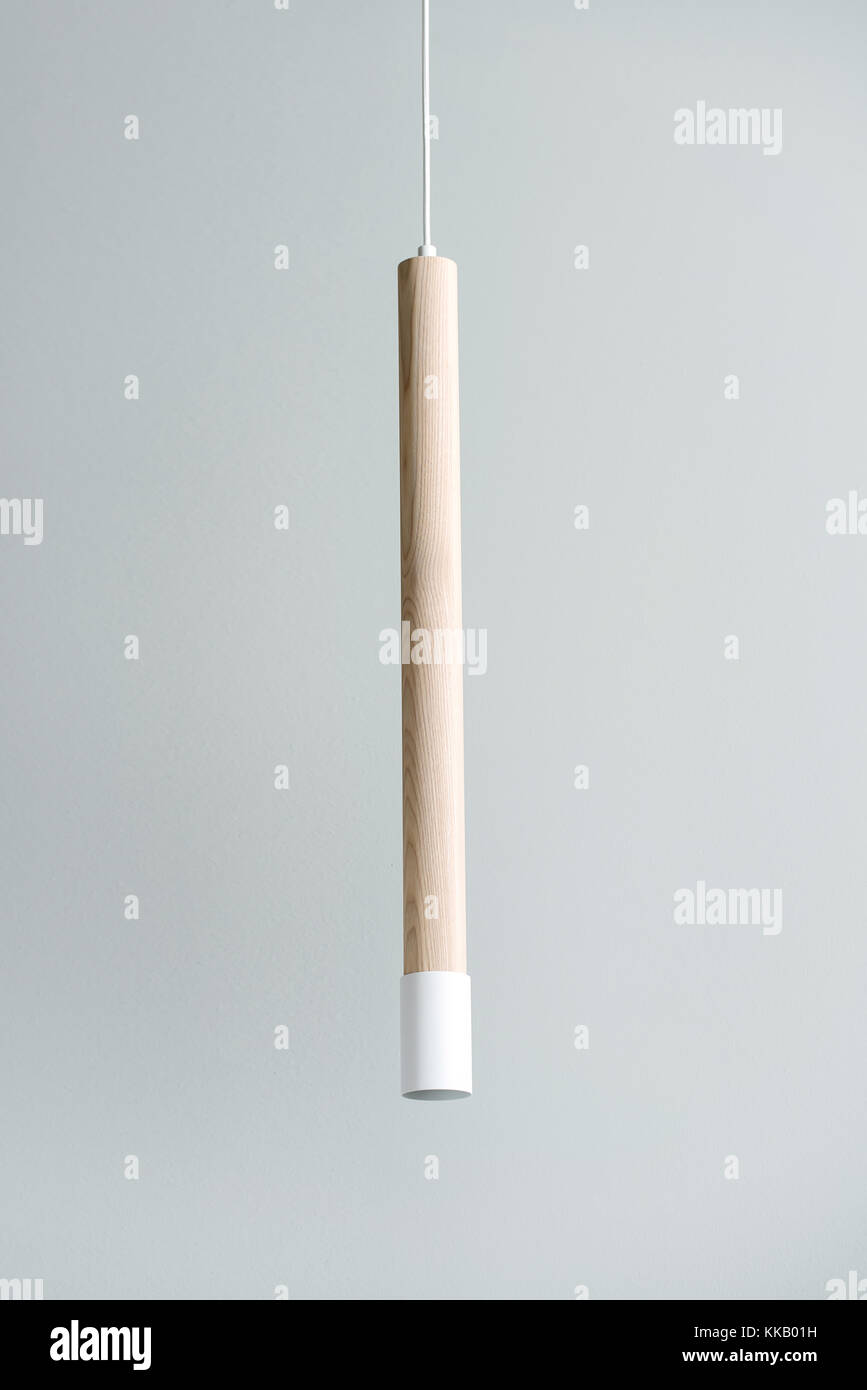Hanging wooden tube lamp with metal part Stock Photo - Alamy