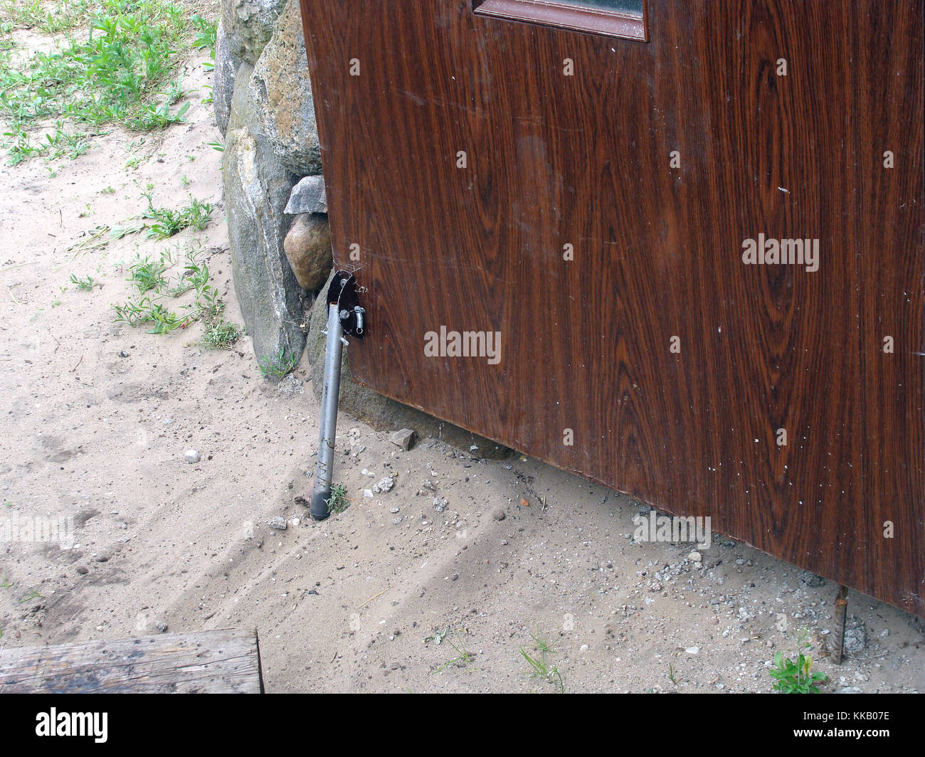 Opened cellar doors with fixator from metal tube and spring Stock Photo ...