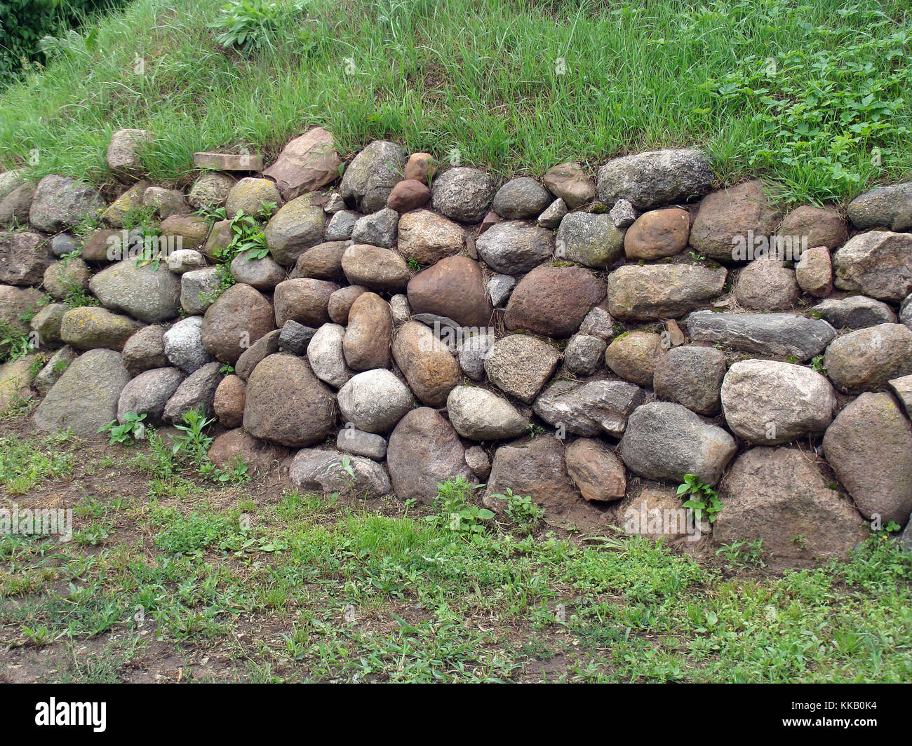 Ground hill protected from slide with stone wall Stock Photo - Alamy