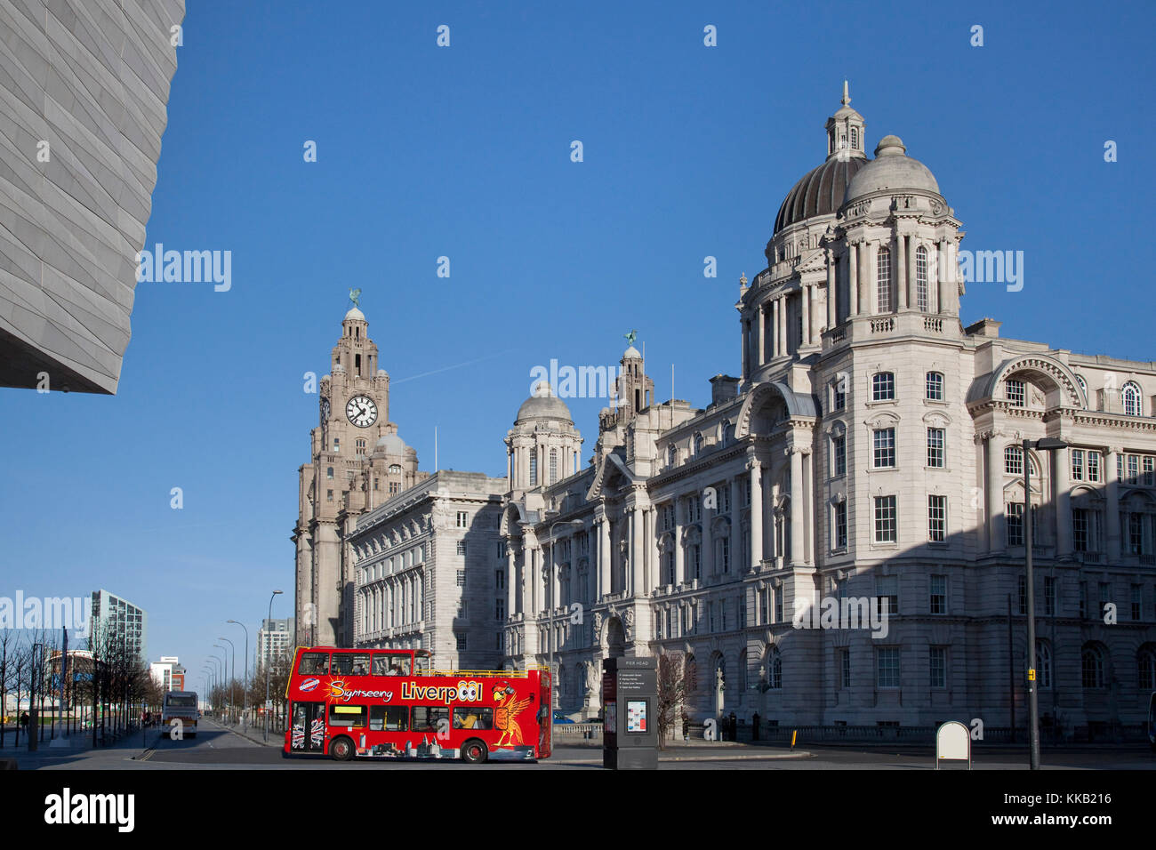 Tourist bus by the Three Graces Liverpool waterfront [wall of Museum of ...