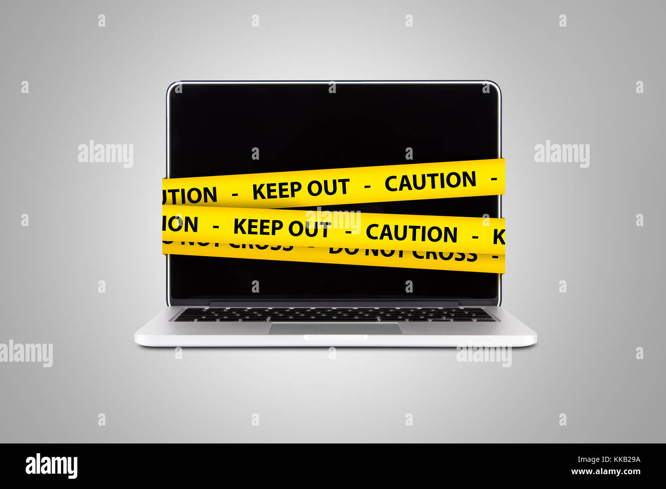 Caution and keep out warning tapes on computer with blank screen ...