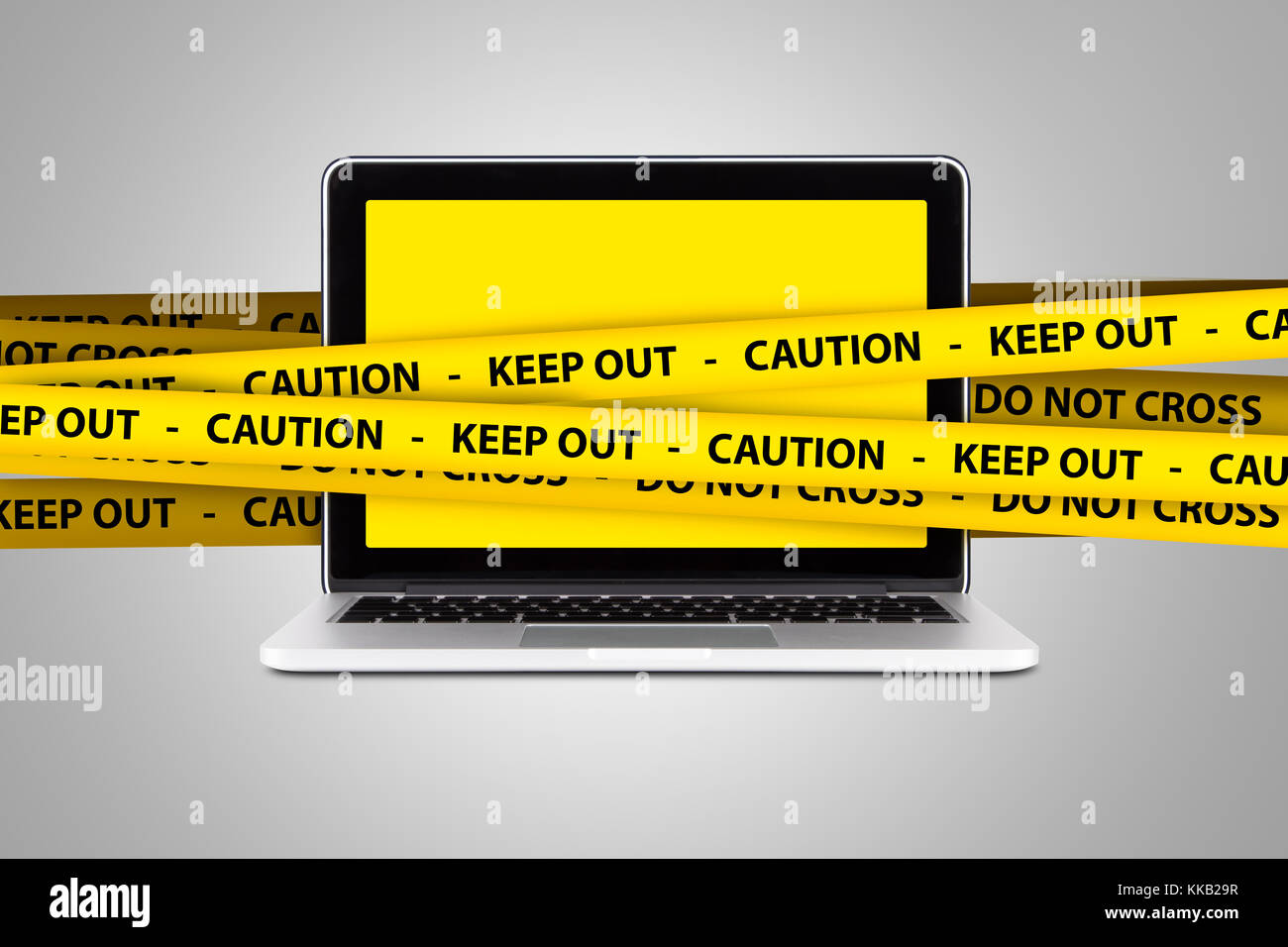 Caution and keep out warning tapes on computer with blank screen Stock ...
