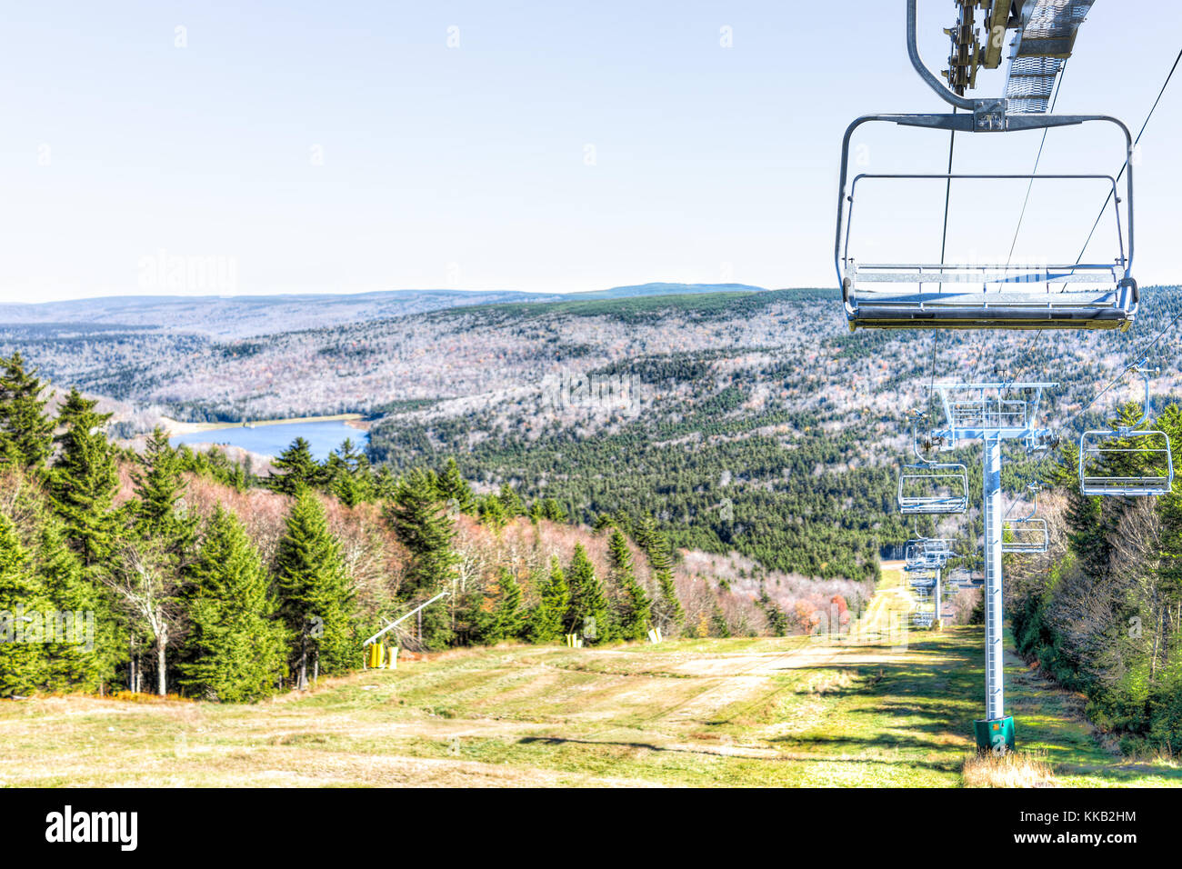 Ski lift with view of mountains and lake, empty, nobody in autumn fall ...