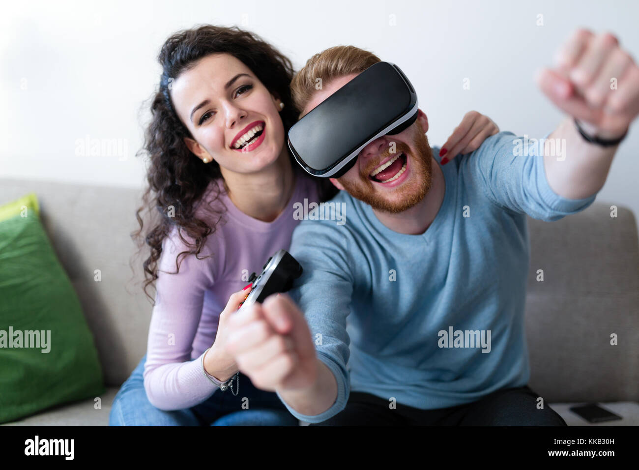 Young couple playing games with virtual reality headset Stock Photo - Alamy
