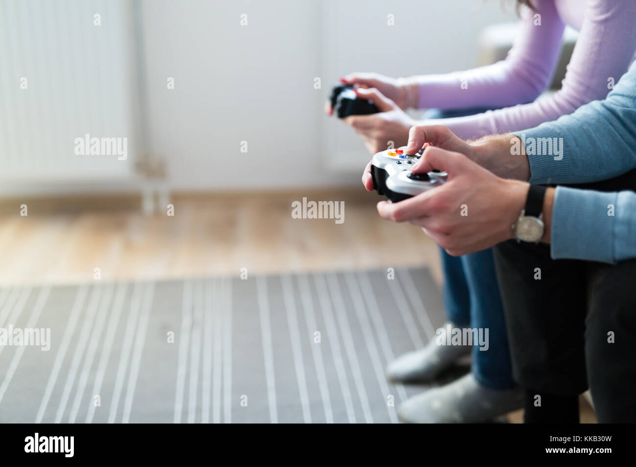 Young couple having fun playing video games Stock Photo - Alamy
