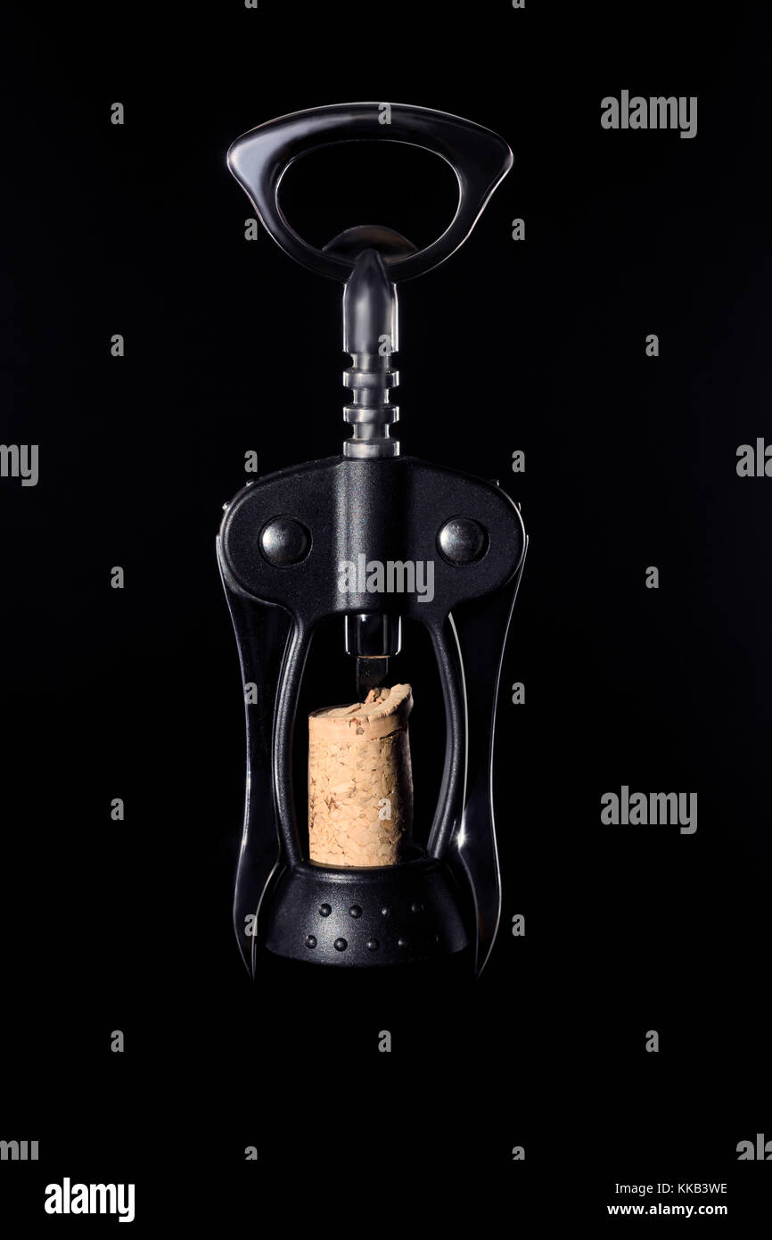 Corkscrew with extracted cork dark background Stock Photo - Alamy