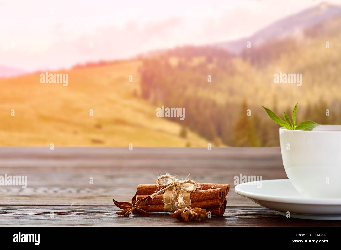 Cup with tea on table over mountains landscape with sunlight. Beauty ...