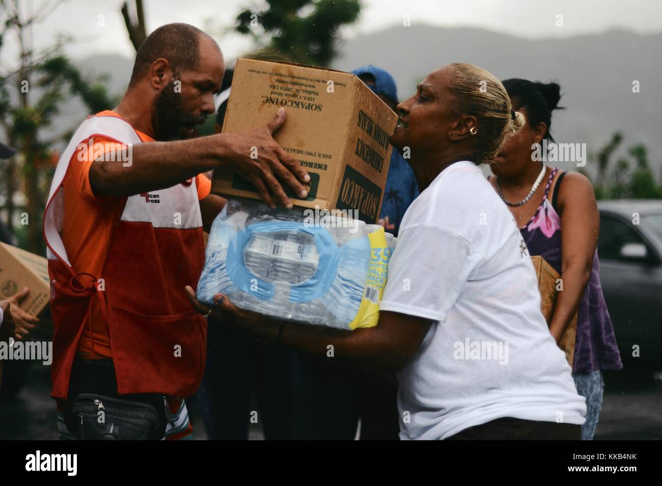 FEMA and American Red Cross volunteers distribute emergency supplies to ...