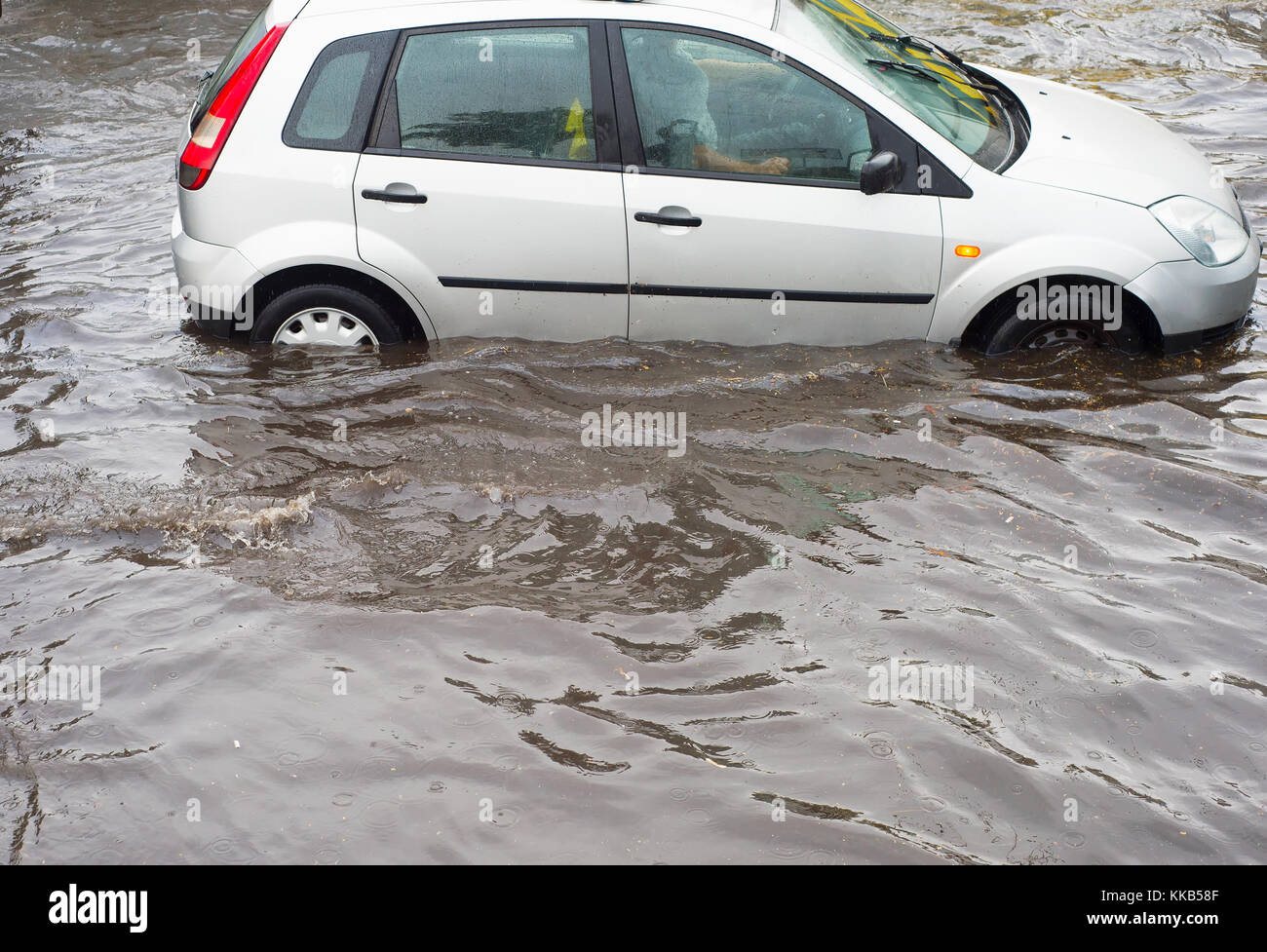 Car on a road flooded by water in a rain. Traffic problem Stock Photo ...