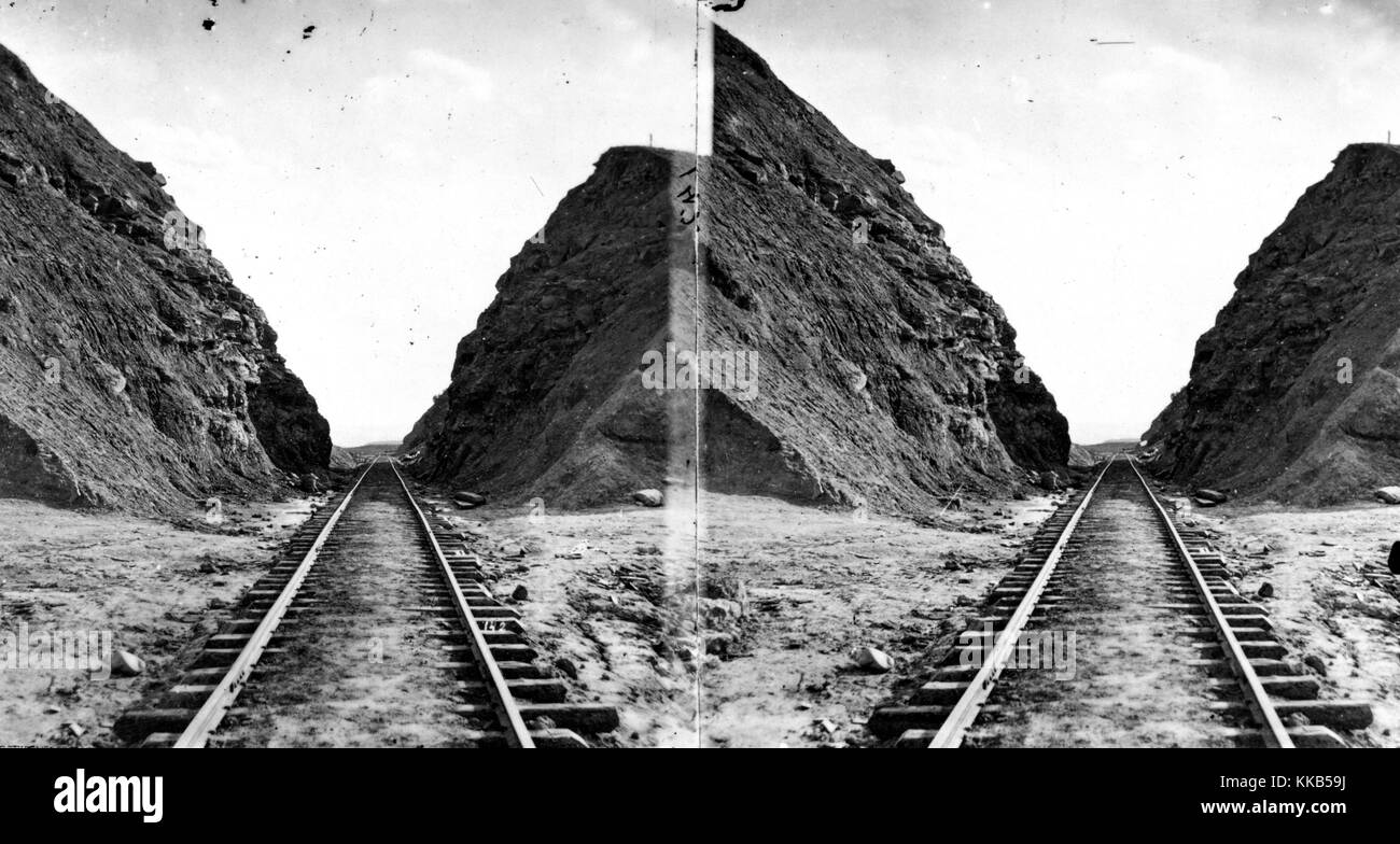 Stereograph of a railroad cut running through the rocky hills near ...