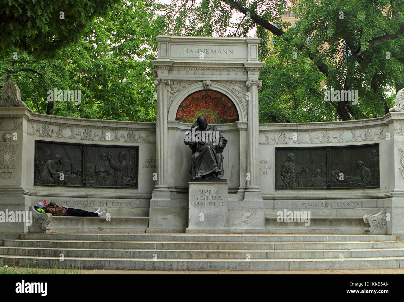 A homeless man taking a nap on the bench of Samuel Hahnemann Monument ...