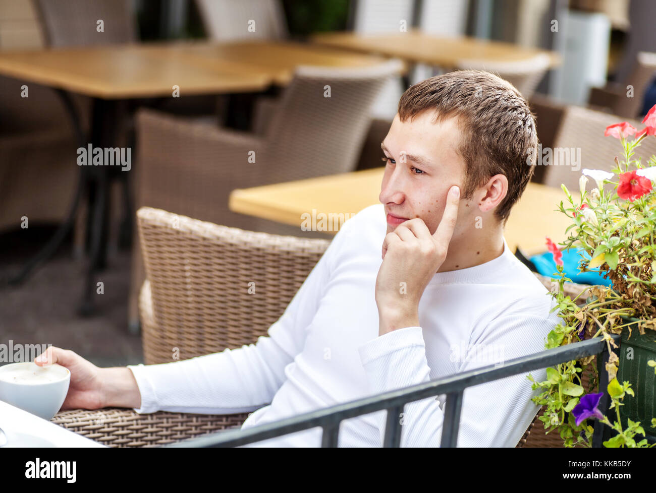 One man drinking coffee at city cafe table outdoors Stock Photo - Alamy