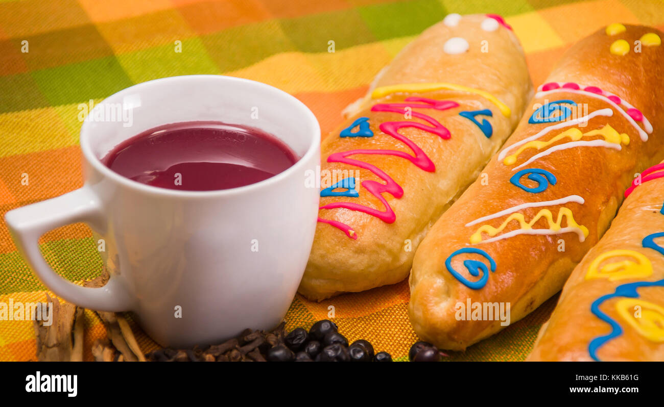 Close up of traditional Ecuadorian dish, colada morada and guaguas de ...