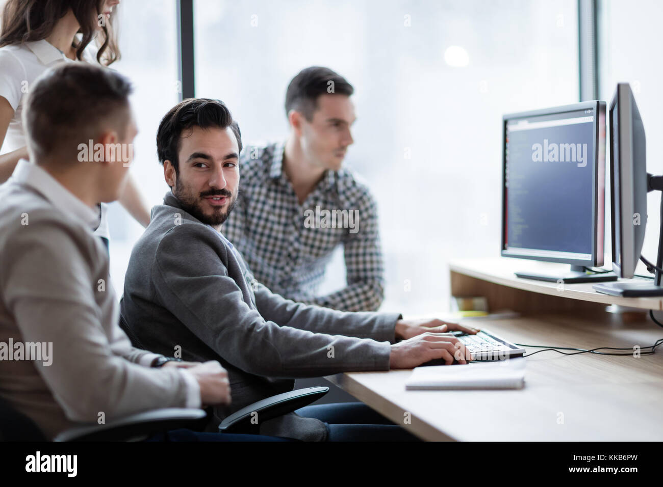 Picture of businesspeople working on computer together Stock Photo - Alamy