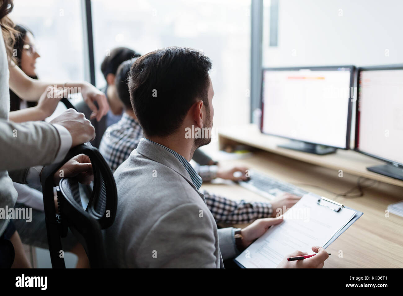 Picture of businesspeople working on computer together Stock Photo - Alamy