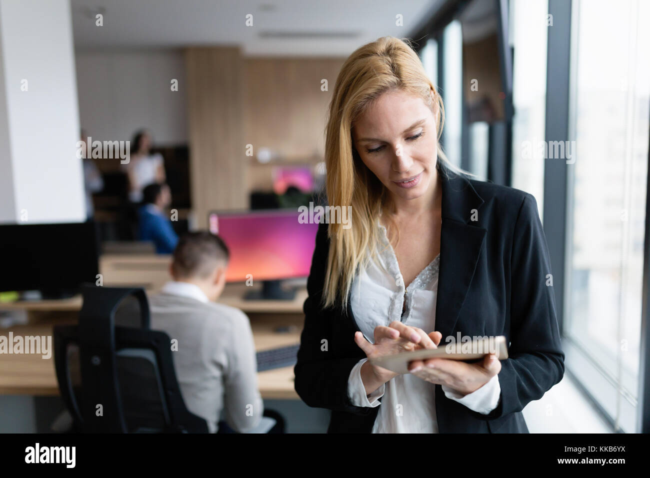 Beautiful businesswoman using digital tablet in office Stock Photo - Alamy