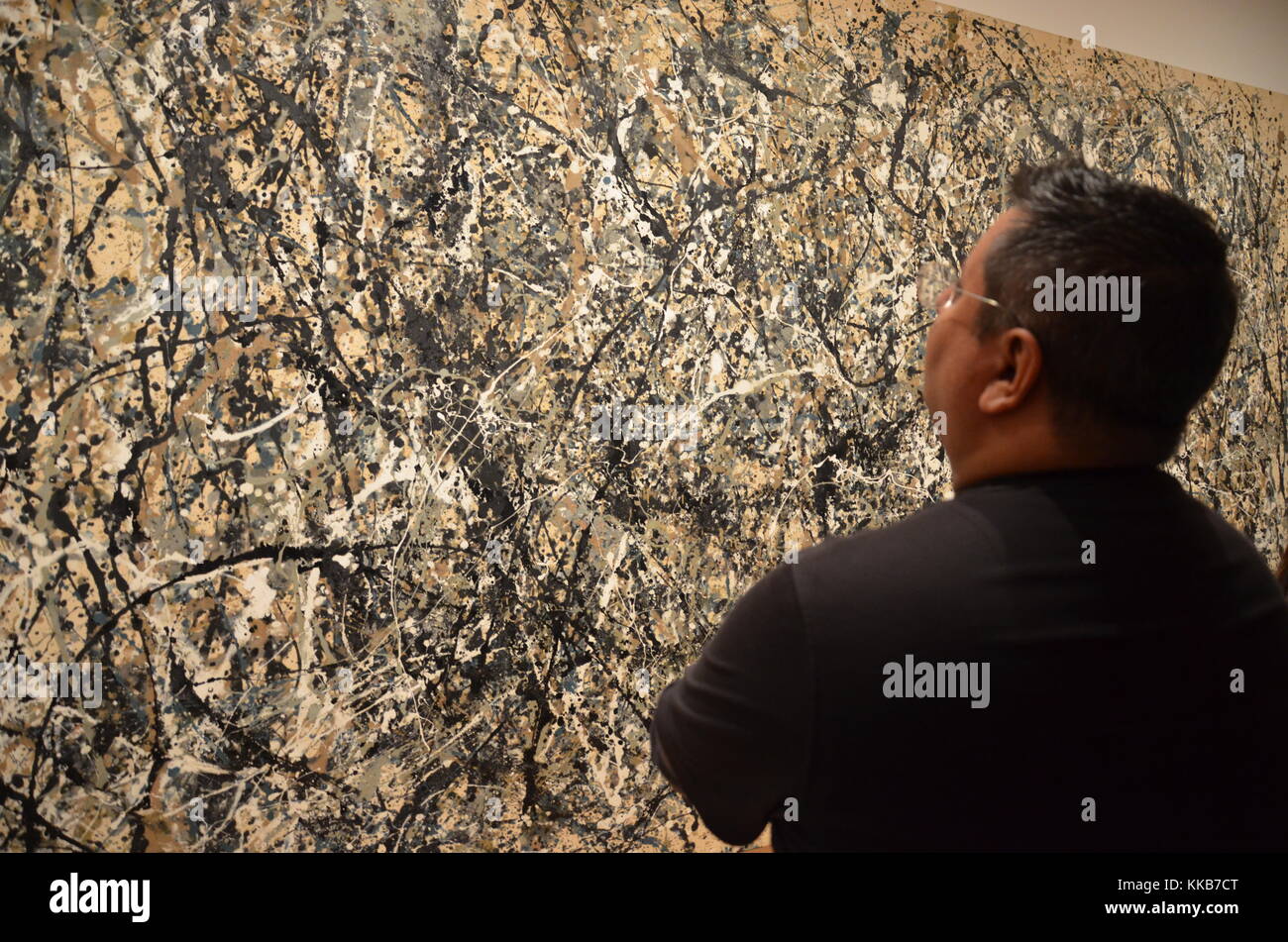 Man looking at Jackson Pollock's painting, 'One: Number 31, 1950' at ...